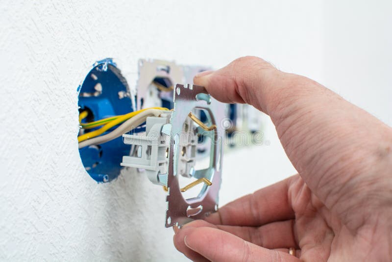 Hands of Electrician Installing Electrical Socket with New Home Stock ...