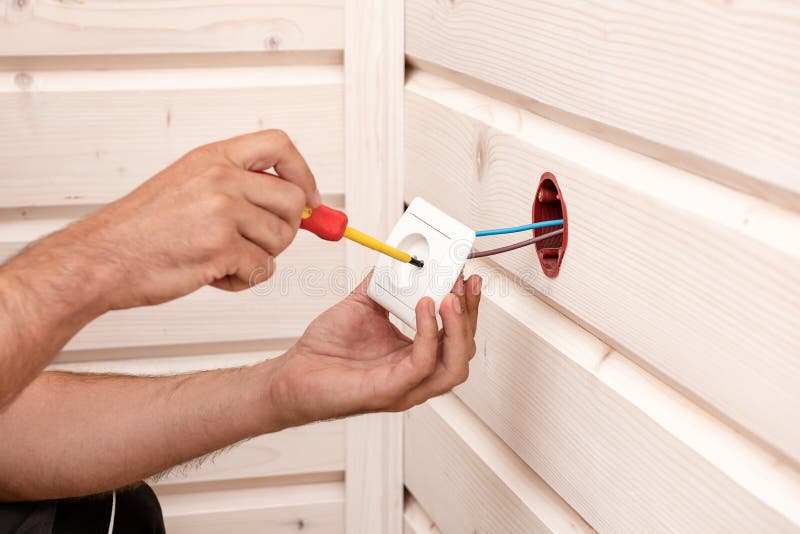 Hands of an Electrician Installing a Socket, Cutting Out a Closeup ...