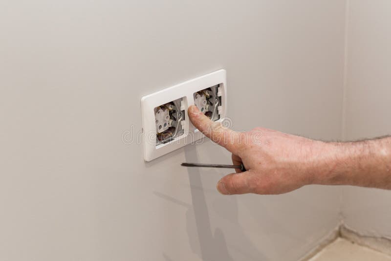The Hands of an Electrician Installing a Wall Power Socket. Stock Photo ...
