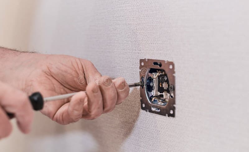 Hands an Electrician Installing a Wall Socket. Assembly of Electrical ...