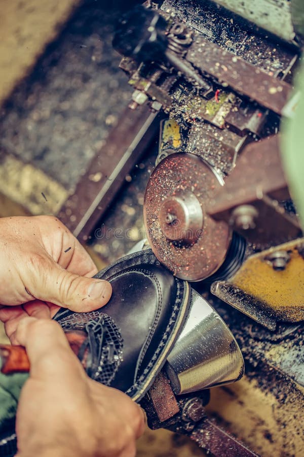 Hands of an Experienced Shoemaker Finishing the Soles of the Shoes, at ...