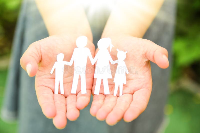 In the Hands of the Family on a Background Paper Stock Photo - Image of ...