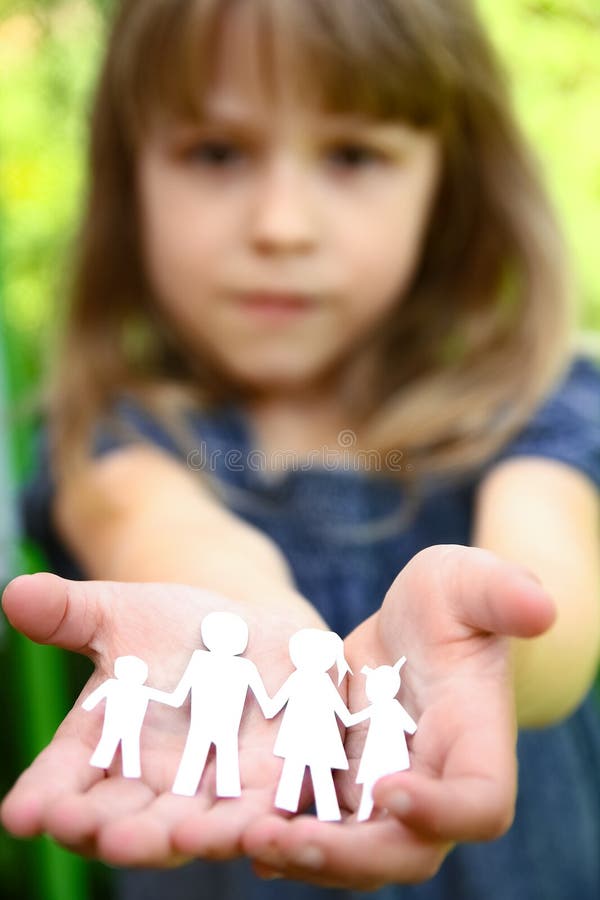 In the Hands of the Family on a Background Paper Stock Photo - Image of ...