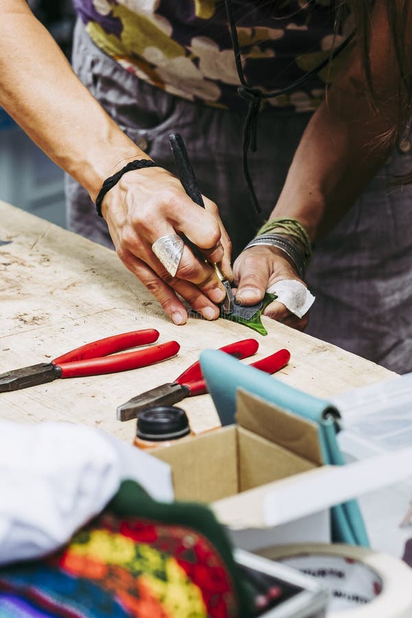Hands of a glass craftsman cutting glass, Hands of a female glass ...