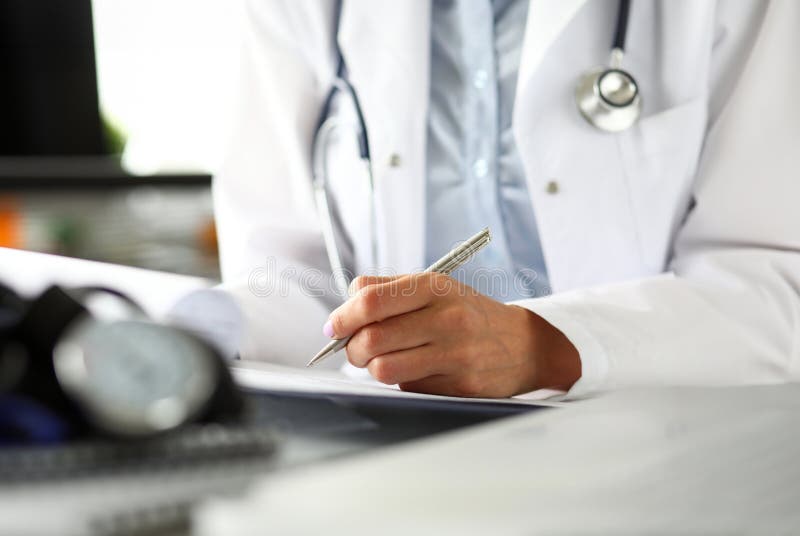 Hands of Female GP Making Notes with Silver Pen Stock Photo - Image of ...