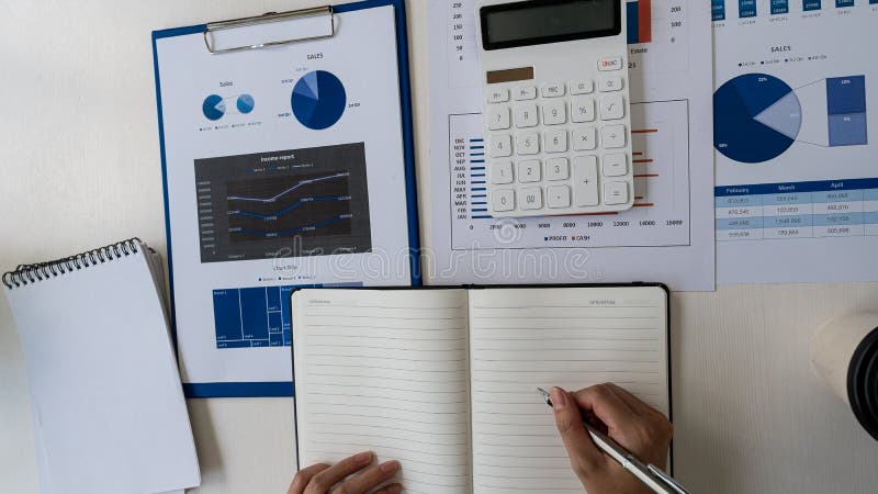 Hands of Financial Manager Analyzing Reports on Desk, Business Plan and ... Hands of Financial Manager Analyzing Reports on Desk, Business Plan and ...