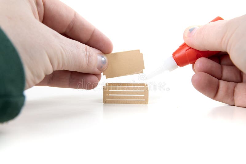 Hands Fixing a Broken Toy Apple Box with Glue Stock Photo - Image of ...