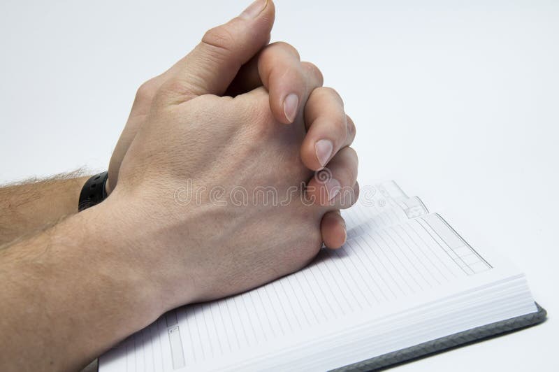 Hands Folded on an Open Notebook. on White Background Stock Photo ...
