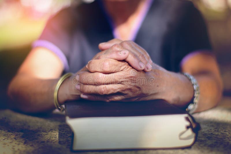 Hands Folded In Prayer On A Holy Bible Stock Image - Image of person ... Hands Folded In Prayer On A Holy Bible Stock Image - Image of person ...