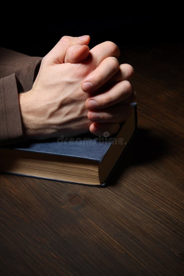 Hands Folded In Prayer Over A Holy Bible Stock Image - Image: 22177923
