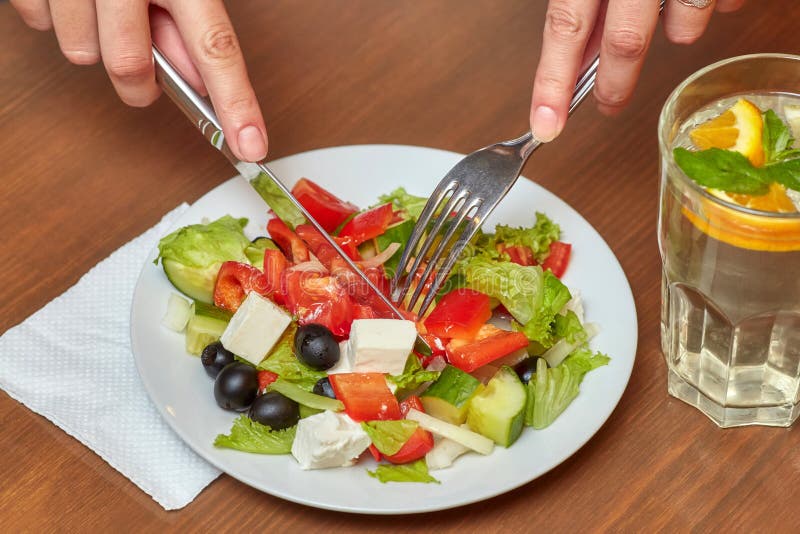Hands with Fork and Knife. Salad and Drink on Table Stock Photo - Image ...