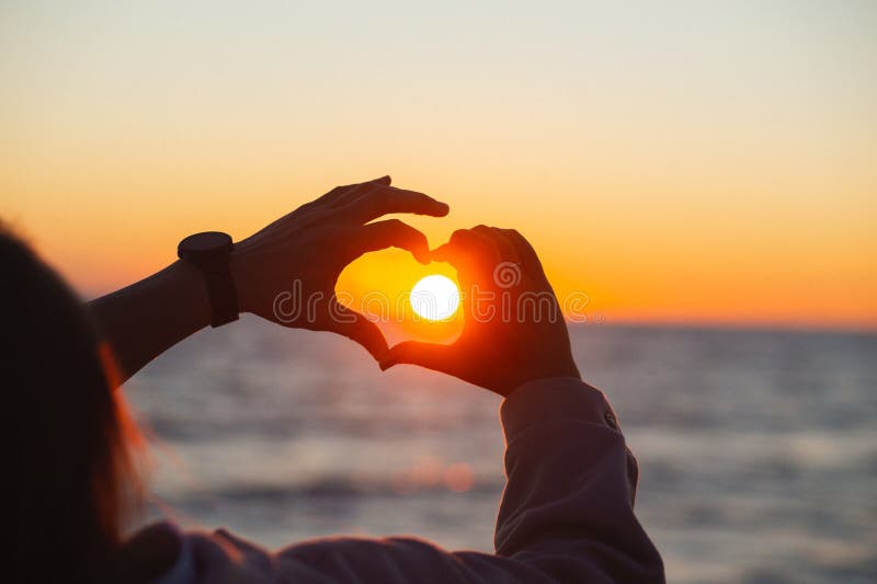 Hands Forming a Heart Shape with Sunset Silhouette on a Sea Stock Photo ...