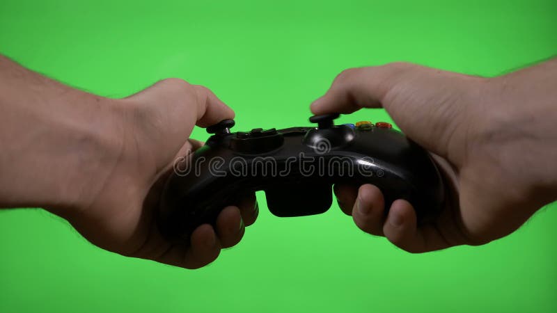 Hands of Dedicated Young Gamer Using a Game Controller with Green ...