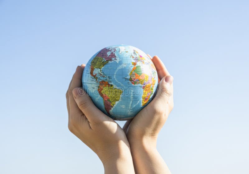 Global Unity Concept with Hands Holding Earth Against Clear Blue Sky Stock Image - Image of ...