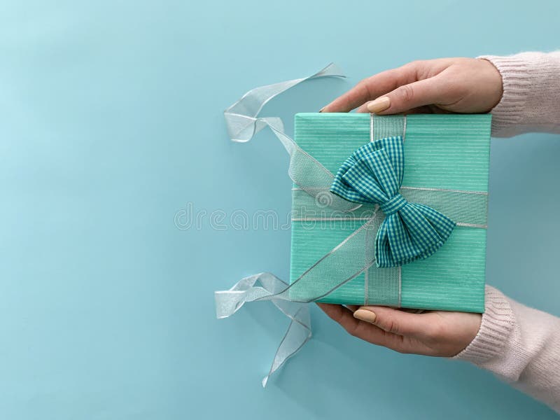Hands Giving Blue Present with Big Bow. Top View of Gift Box Over ...