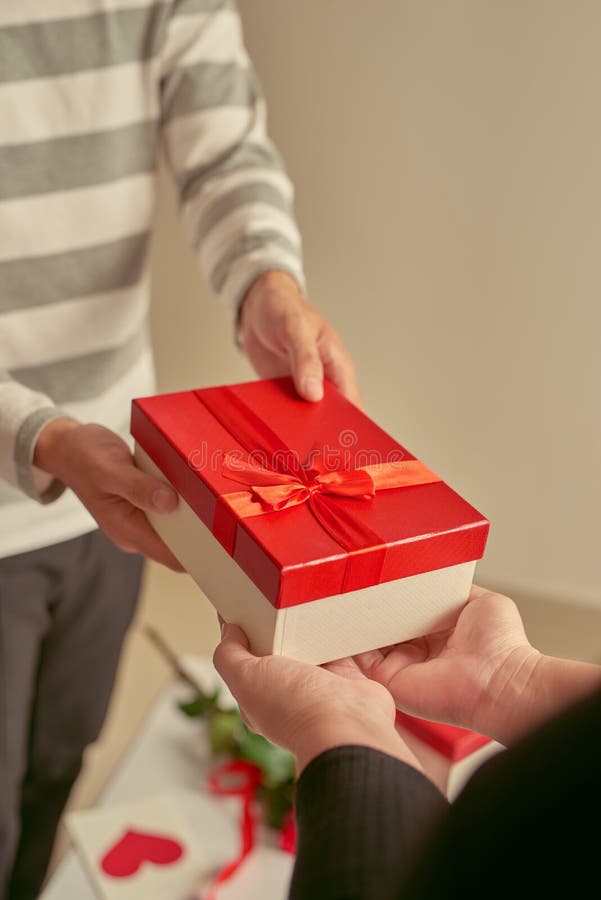 Hands Giving and Receiving a Red Present Stock Image - Image of home ...