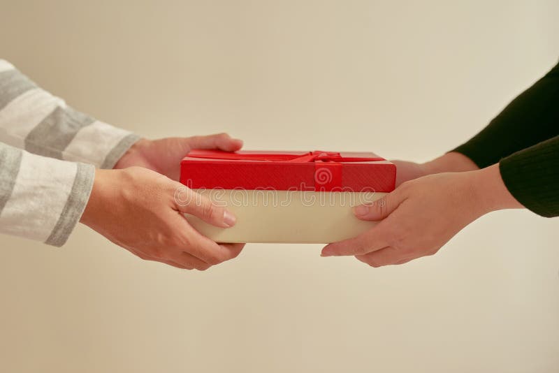 Hands Giving and Receiving a Red Present Stock Image - Image of package ...