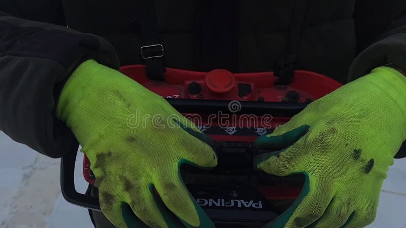 Hands with Gloves Hold Equipment for Work on Construction Site. Remote ...