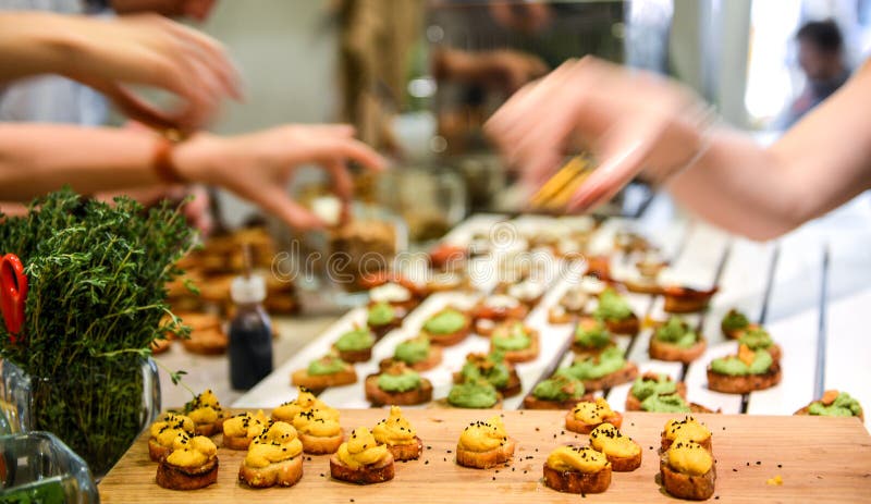 Hands Grabbing Snacks from Table in Blurred Motion Stock Photo - Image ...