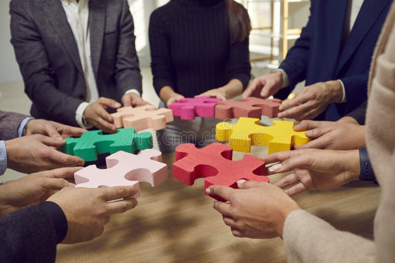 Hands of a Group of Business People Assembling Jigsaw Puzzle ...