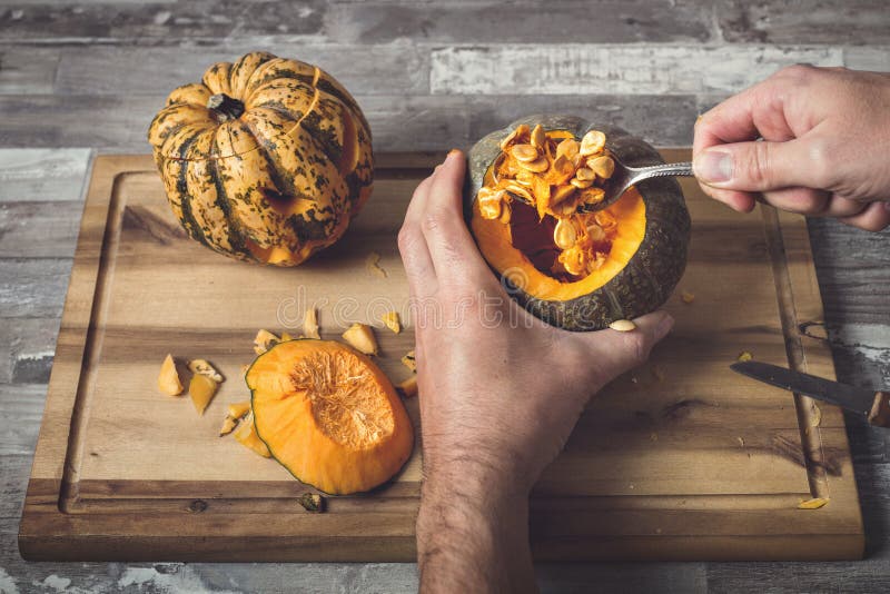 Hands Hallowing Out a Pumpkin Stock Image - Image of food, seed: 154608125