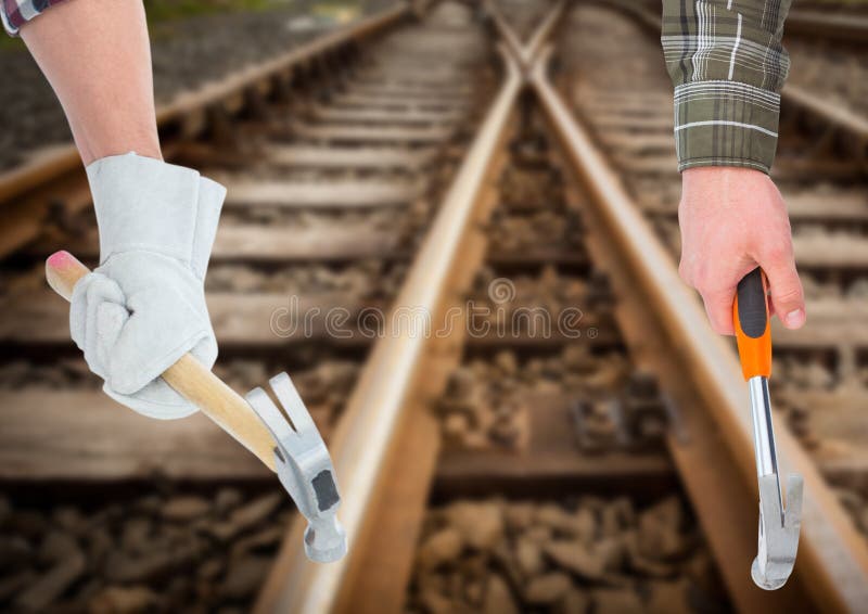 Hands with Hammers in the Railroad Tracks Stock Photo - Image of ...