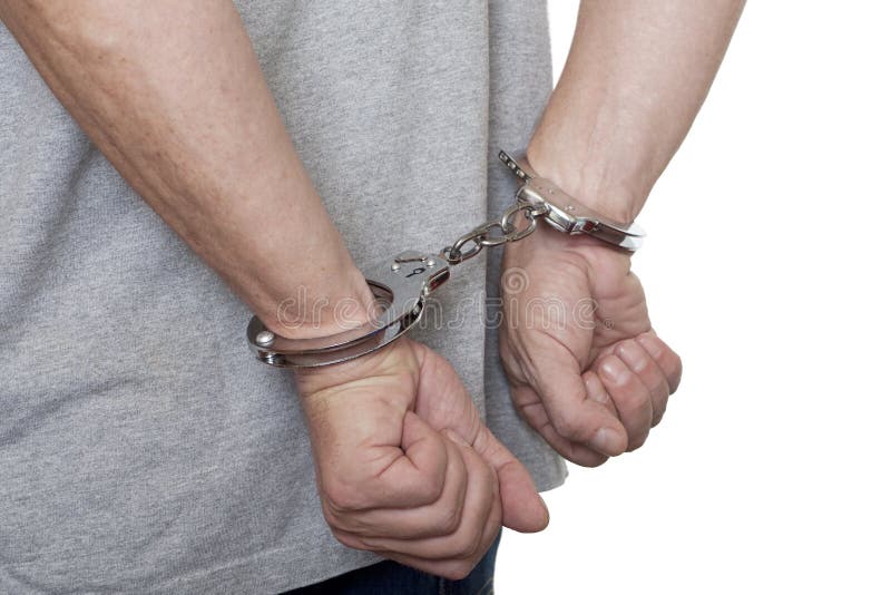 Handcuffs on hands stock photo. Image of human, isolated - 18130178