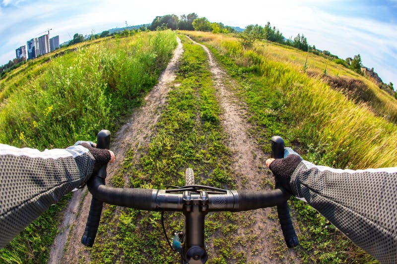 Hands on the Handlebars of a Bicycle of a Cyclist Riding Along a Trail ...