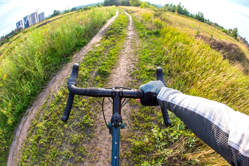 Hands on the Handlebars of a Bicycle of a Cyclist Riding Along a Trail ...
