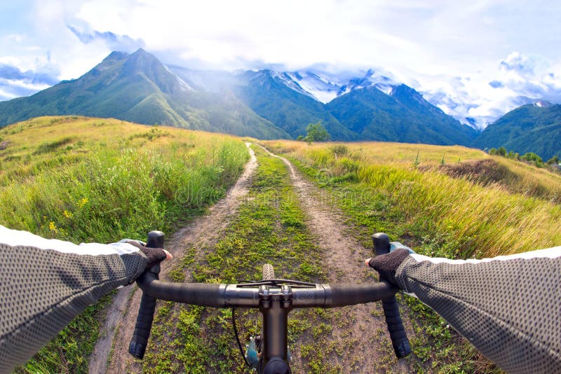 Hands on the Handlebars of a Bicycle of a Cyclist Riding Along a Trail ...
