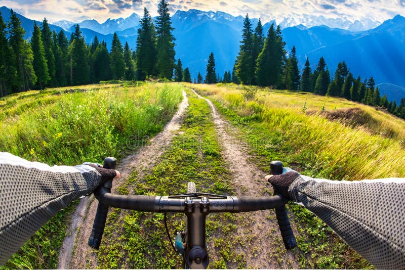 Hands on the Handlebars of a Bicycle of a Cyclist Riding Along a Trail ...