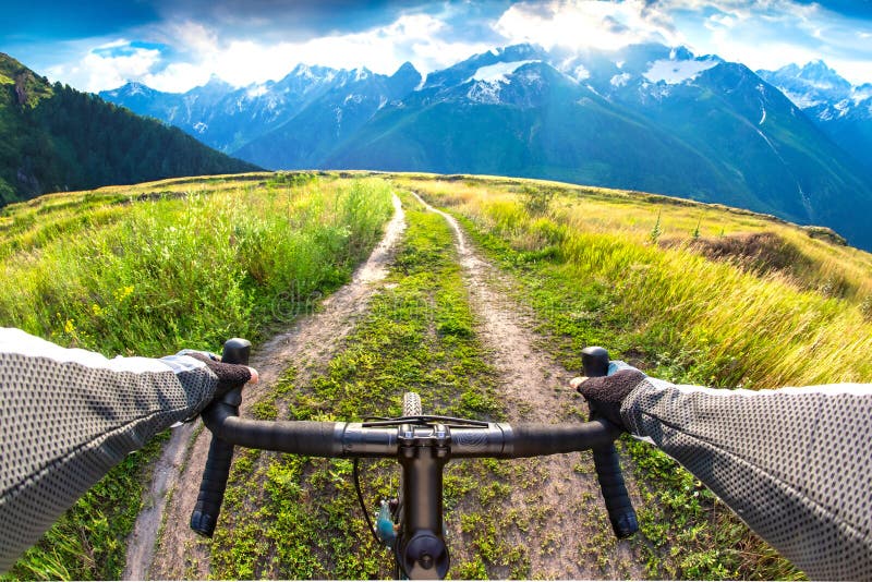 Hands on the Handlebars of a Bicycle of a Cyclist Riding Along a Trail ...