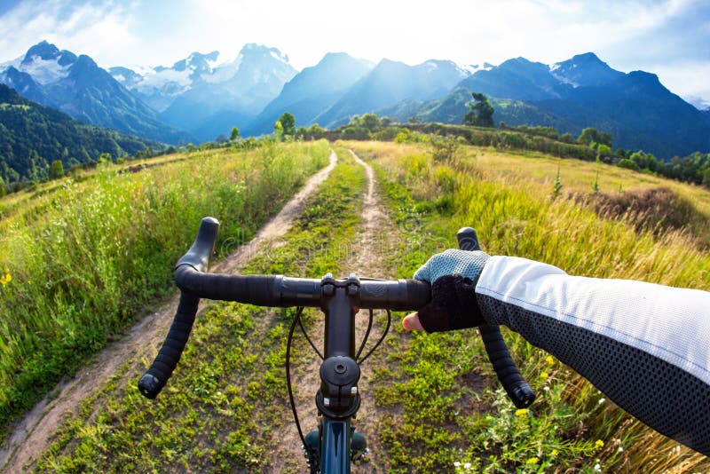 Hands on the Handlebars of a Bicycle of a Cyclist Riding Along a Trail ...