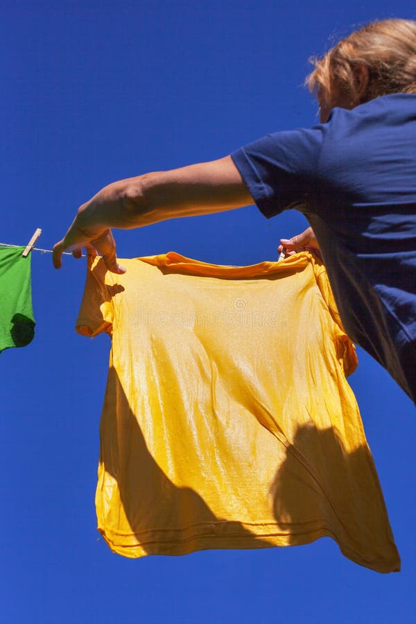 Hands hanging clothes. stock photo. Image of laundry - 26395550
