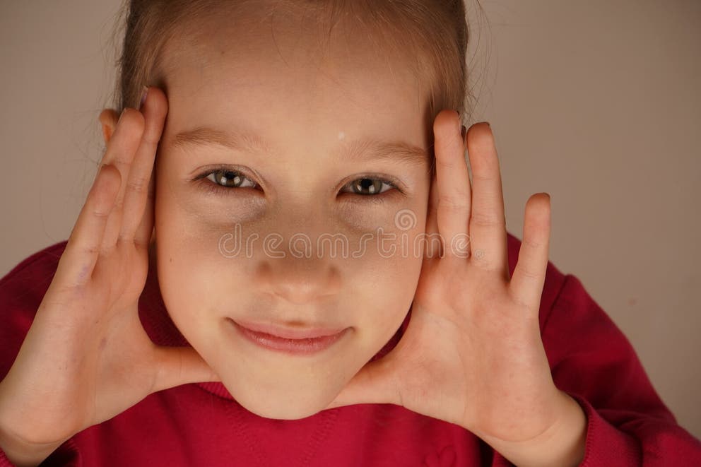 With Hands by Her Temples, the Girl Blocks Her Peripheral View ...