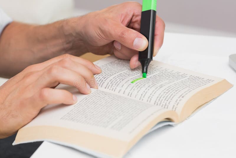 Hands Highlighting Text in Book on the Table Stock Image - Image of ...