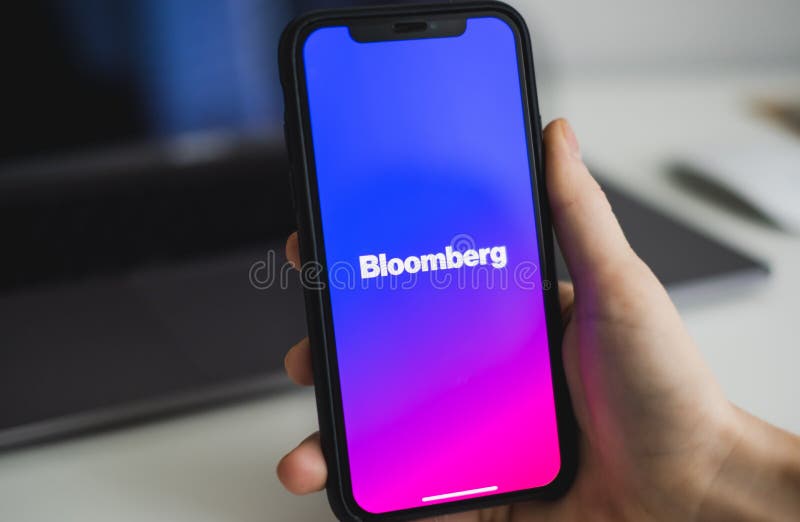 Hands Hold the IPhone with Bloomberg App Logo on the Screen Editorial ...