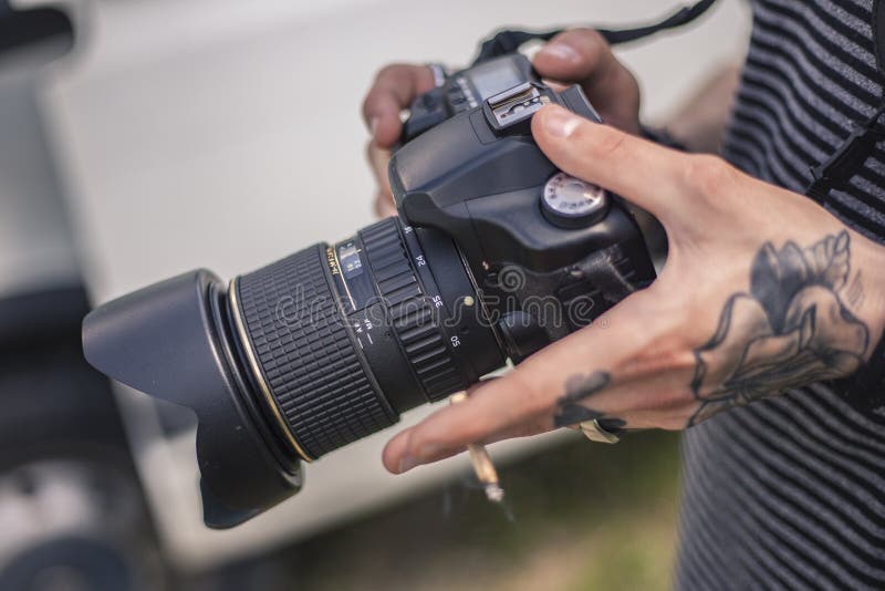 Hands hold reflex camera editorial stock photo. Image of caucasian ...