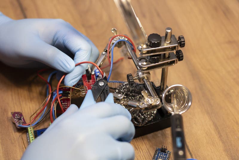 Hands Hold Side Cutters and Cut the Wire, Soldering the Board with a ...