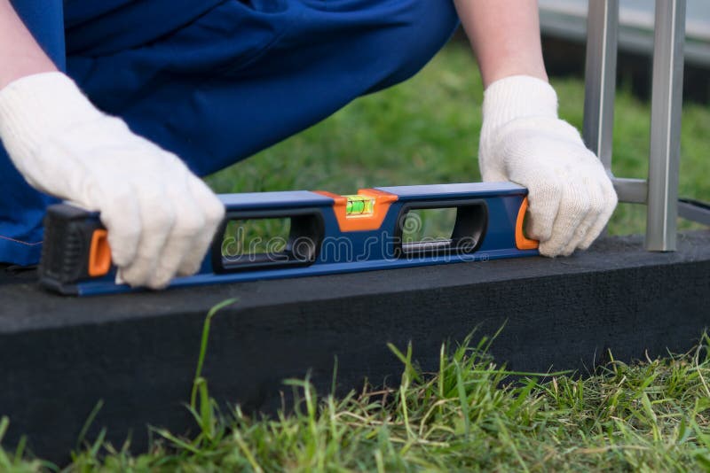 The Hands Hold a Tool To Measure the Level of the Foundation Stock ...