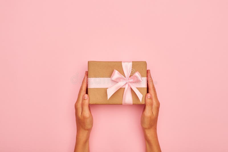 Hands Holding Beautiful Gift Box on Pink Flatlay Stock Photo - Image of ...