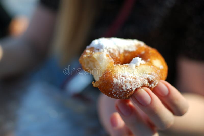 Hands Holding Bited Donut Dusted with Powdered Sugar Close Up. Stock ...