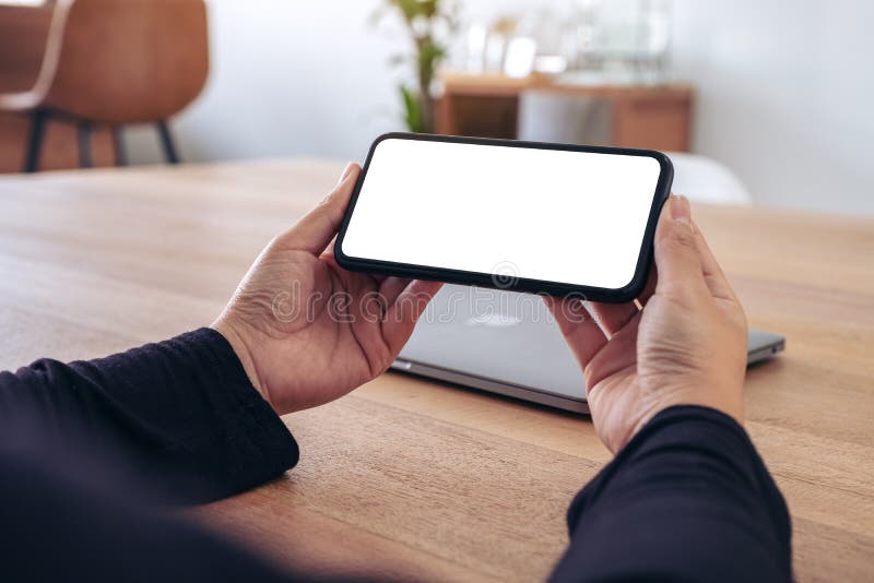 Hands Holding Black Mobile Phone with Blank White Screen Horizontally ...
