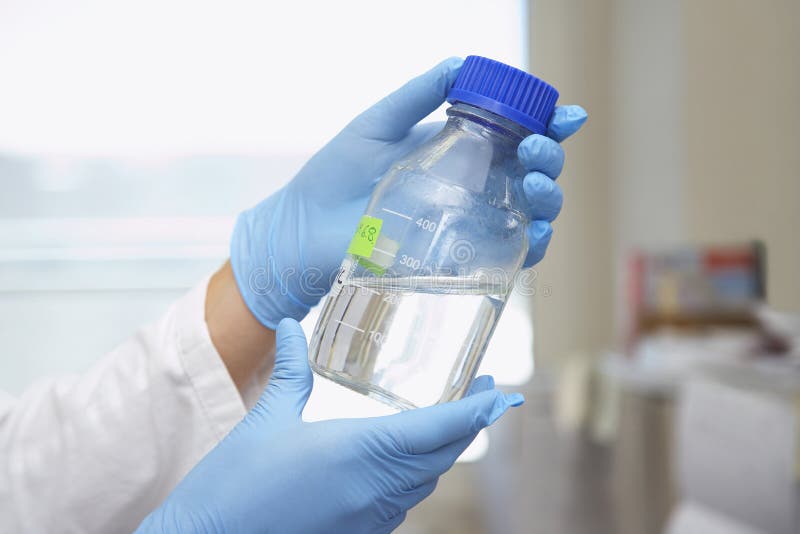 Hands Holding Bottle of Solution in Laboratory Stock Image - Image of ...