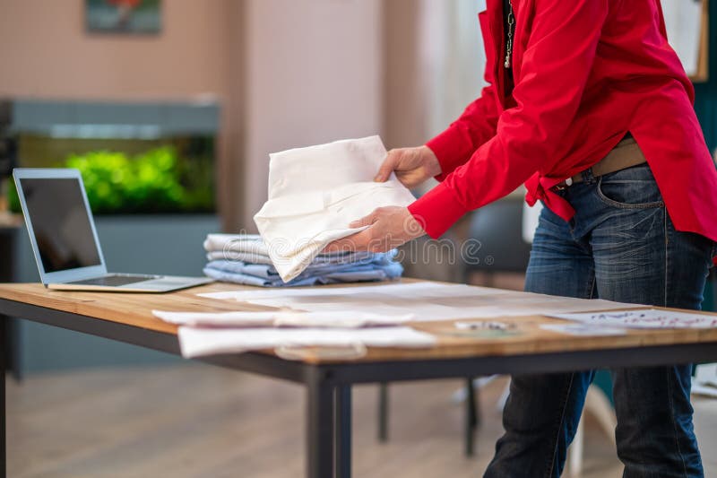 Hands Holding Bundle Over Table in Atelier Stock Photo - Image of ...