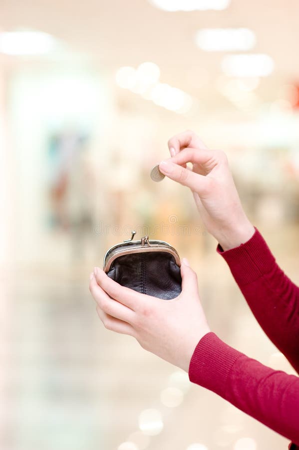 Hands Holding Coin and Retro Styled Money Pouch in Stock Photo - Image ...