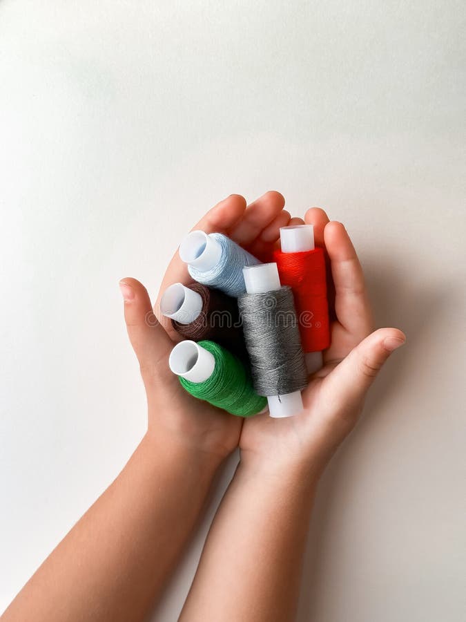 Hands Holding Colorful Thread Spools for Sewing and Crafting Creativity ...