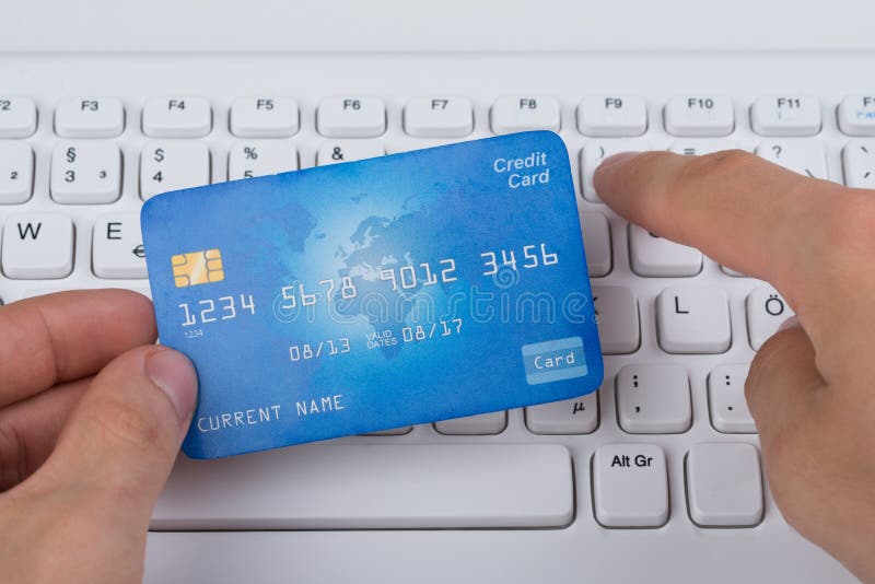 Hands Holding Credit Card on a Keyboard Stock Photo - Image of laptop ...