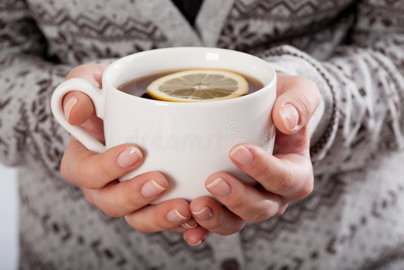 Hands holding a cup of tea stock photo. Image of hand - 46877062