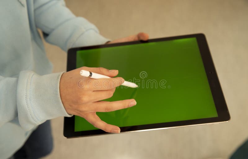 Hands are Holding a Drawing Tablet. Tablet with Stis, Green Screen ...